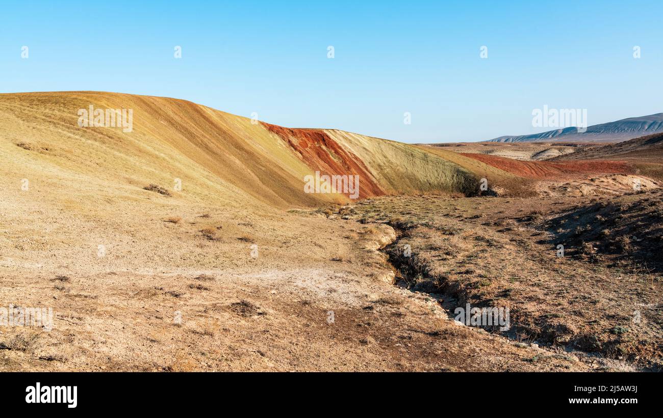 Red sand mountains in the desert area Stock Photo - Alamy