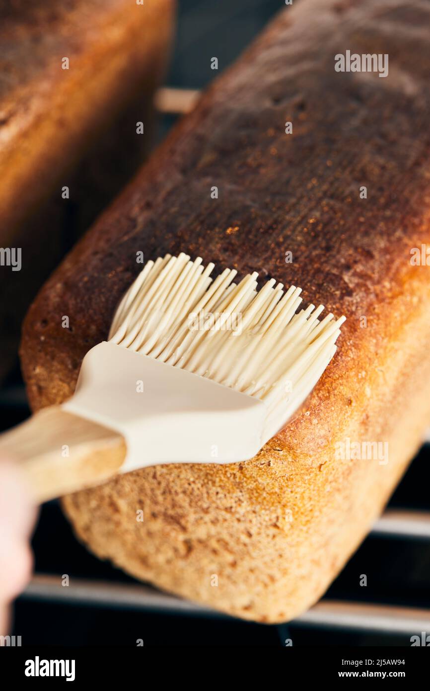 The process of making rye molded bread. Coating the finished bread with ...