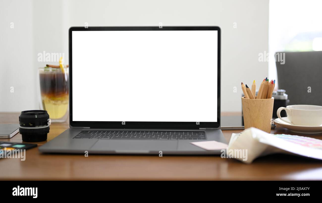 Notebook laptop computer white screen mockup with supplies and stuff on ...