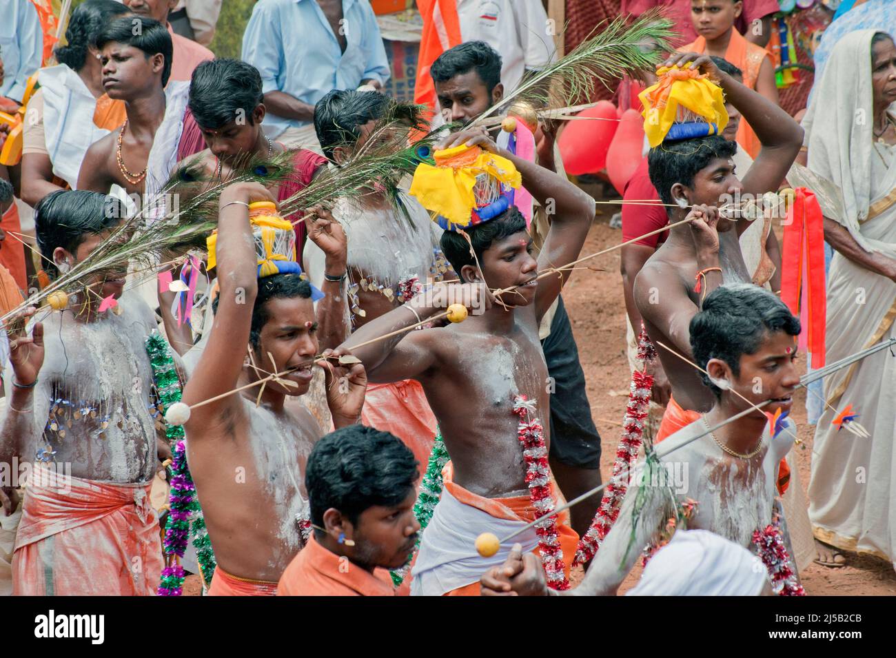 Group of men piercing spikes through cheeks discharging vow in ...