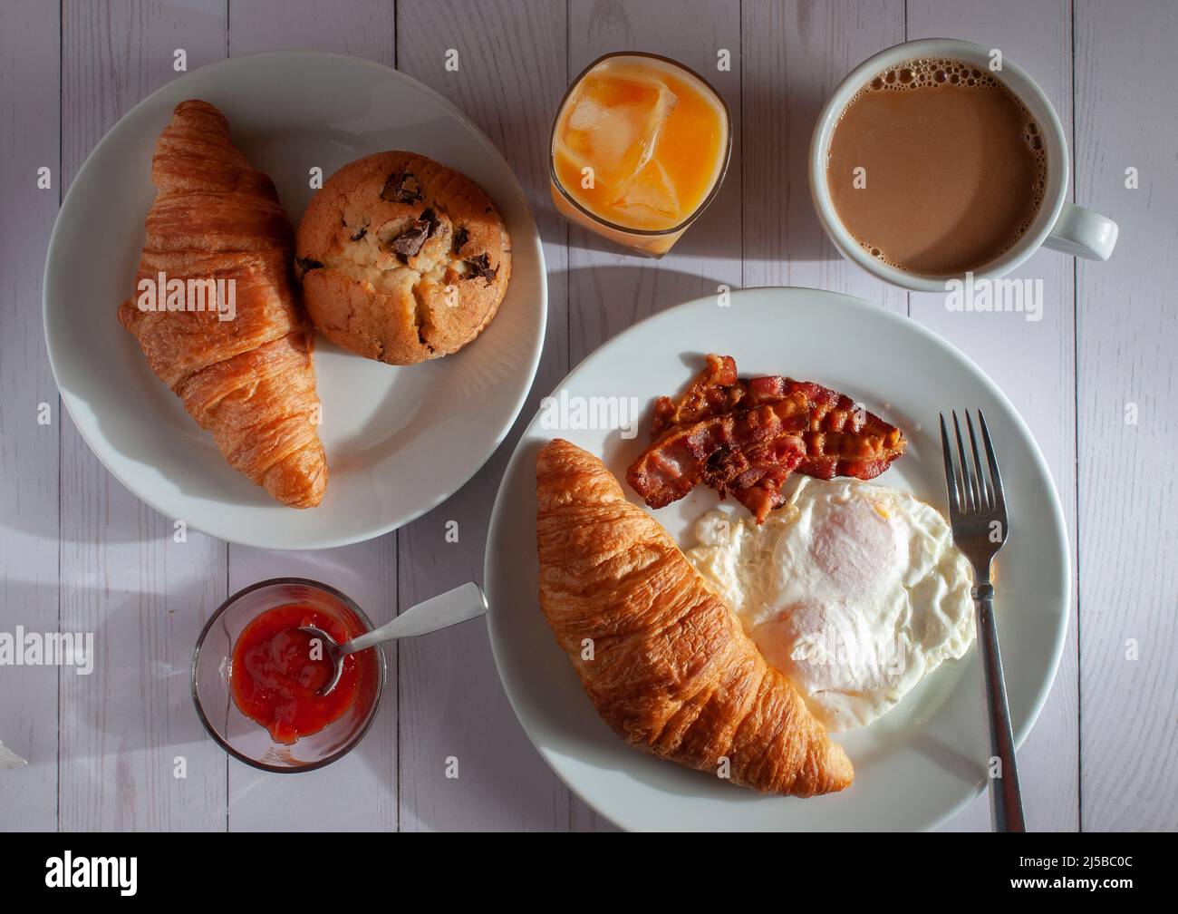 American breakfast with overmedium eggs, bacon, bread orange juice and ...