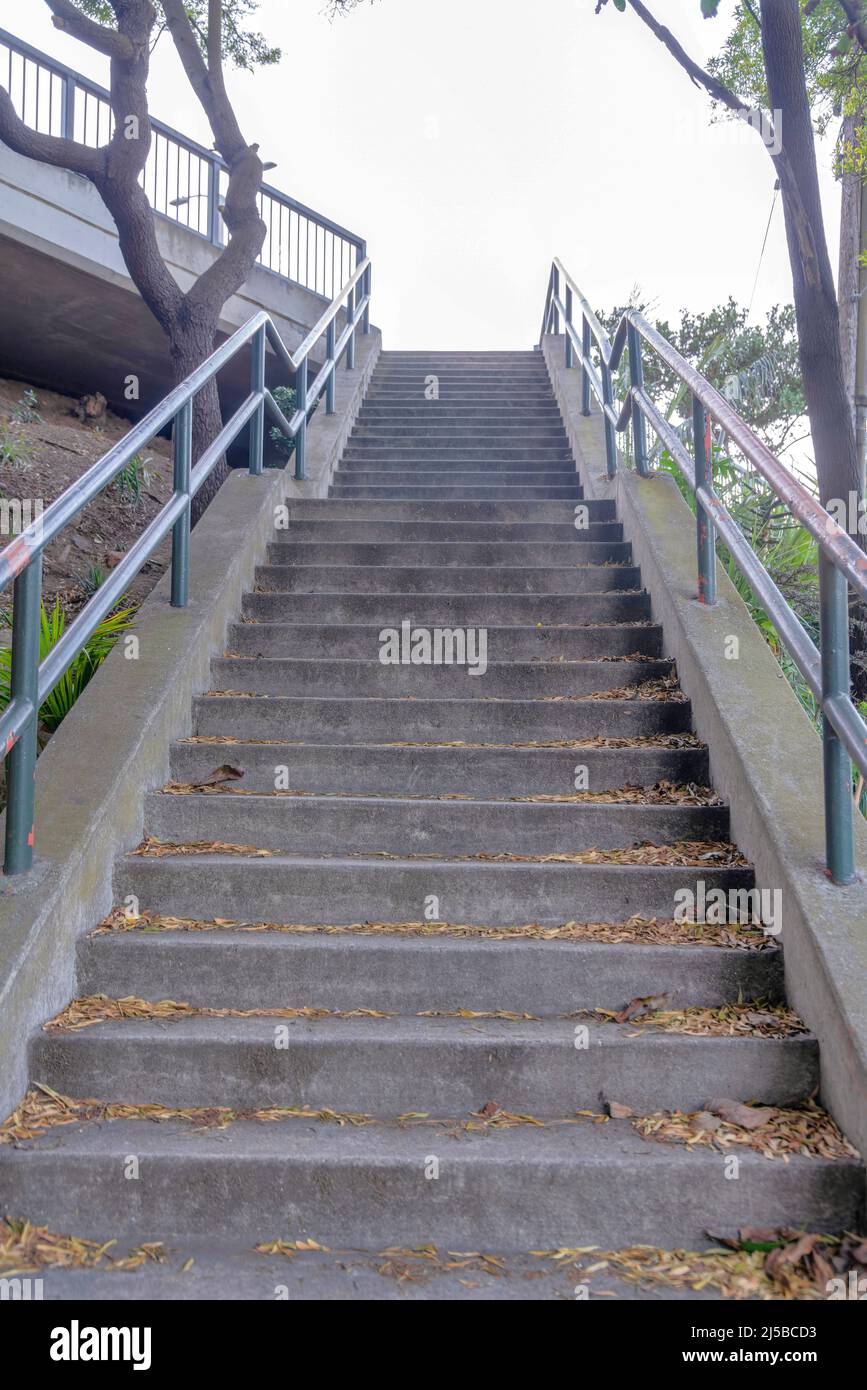 Outdoor staircase with concrete steps and metal bar railings at San ...