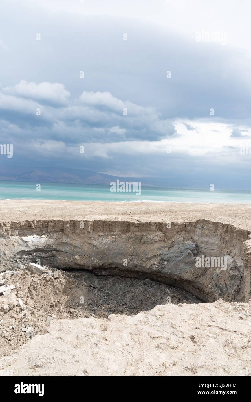 Sinkhole filled with turquoise water, near Dead Sea coastline. Hole ...