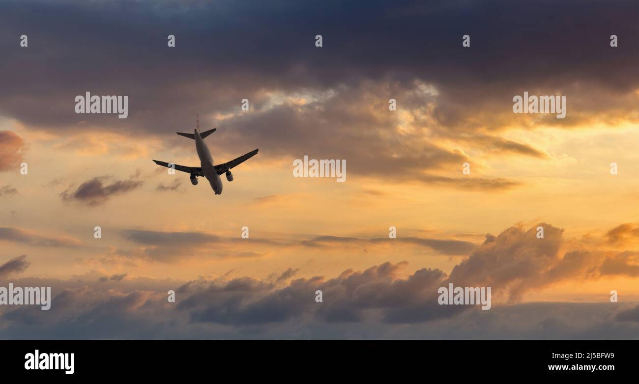 Aircraft flyingon a sunset background Stock Photo - Alamy