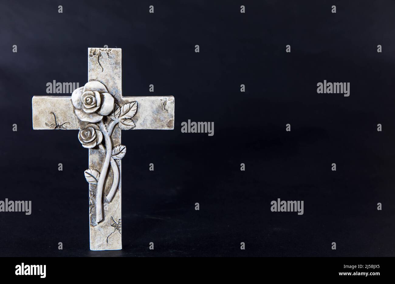 Isolated ornate religious cross with on a dark background. Moment of ...