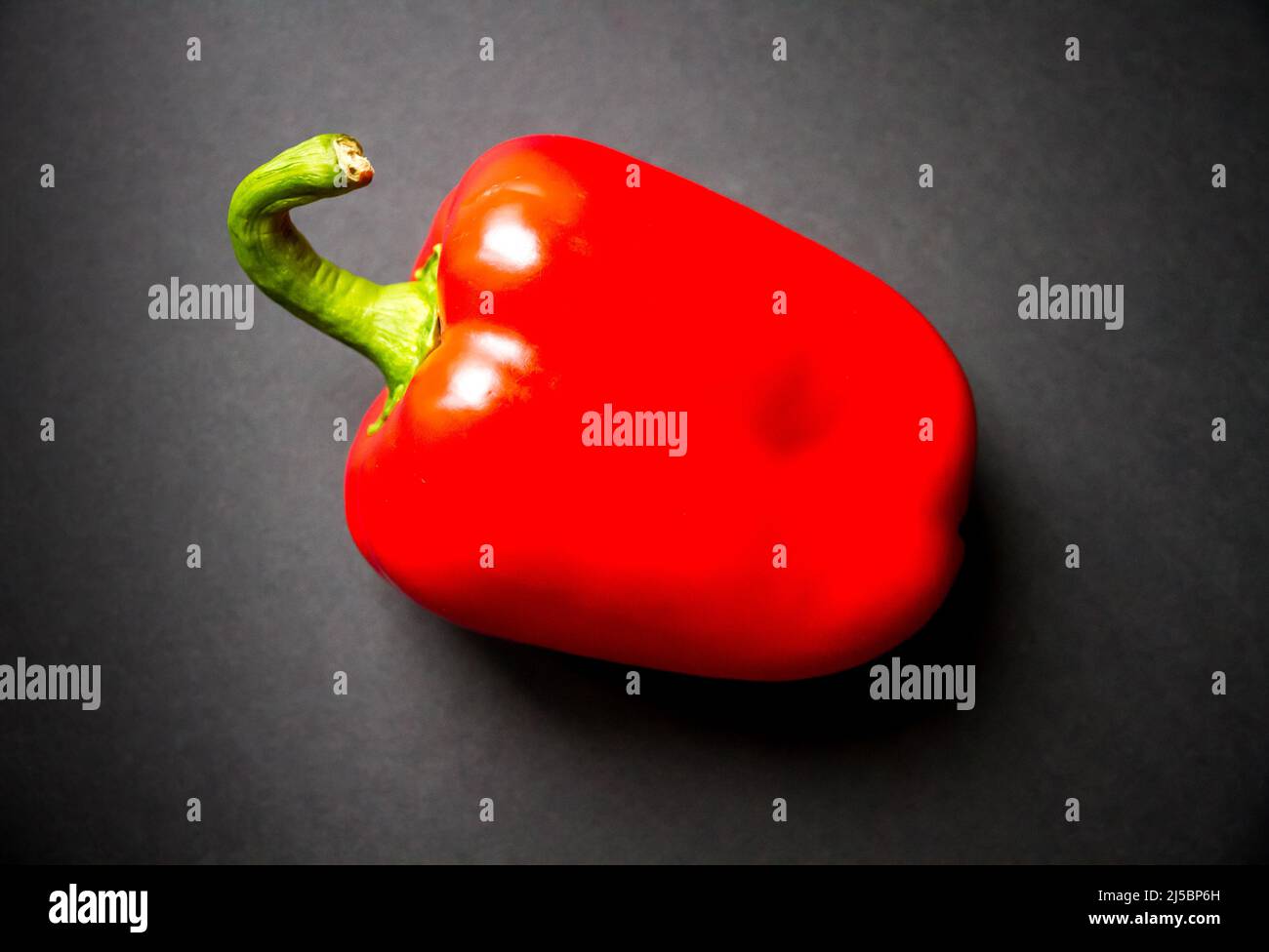 Fresh organic red bell pepper isolated on black background Stock Photo ...