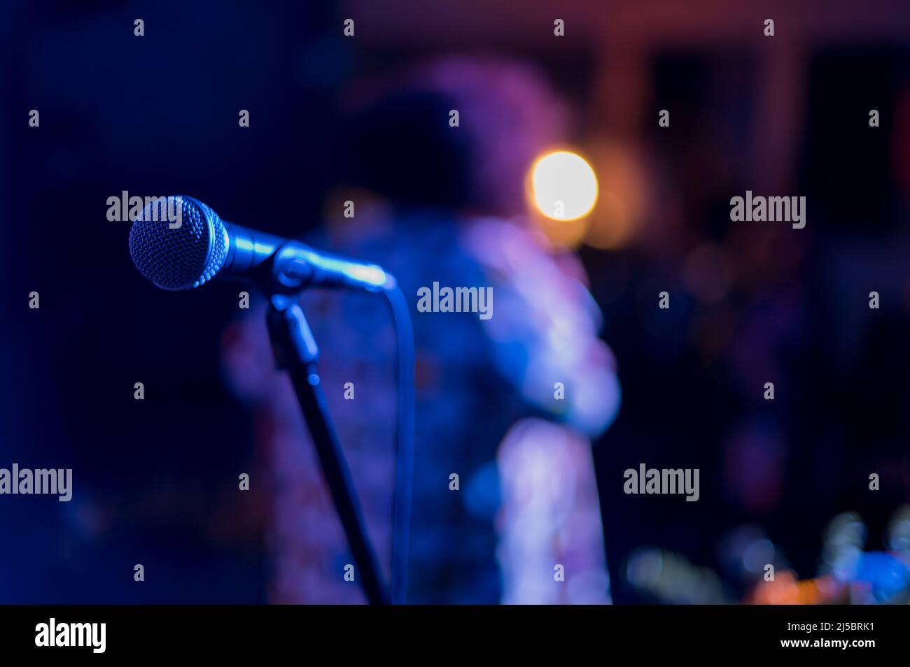Microphone on stage during performance Stock Photo - Alamy