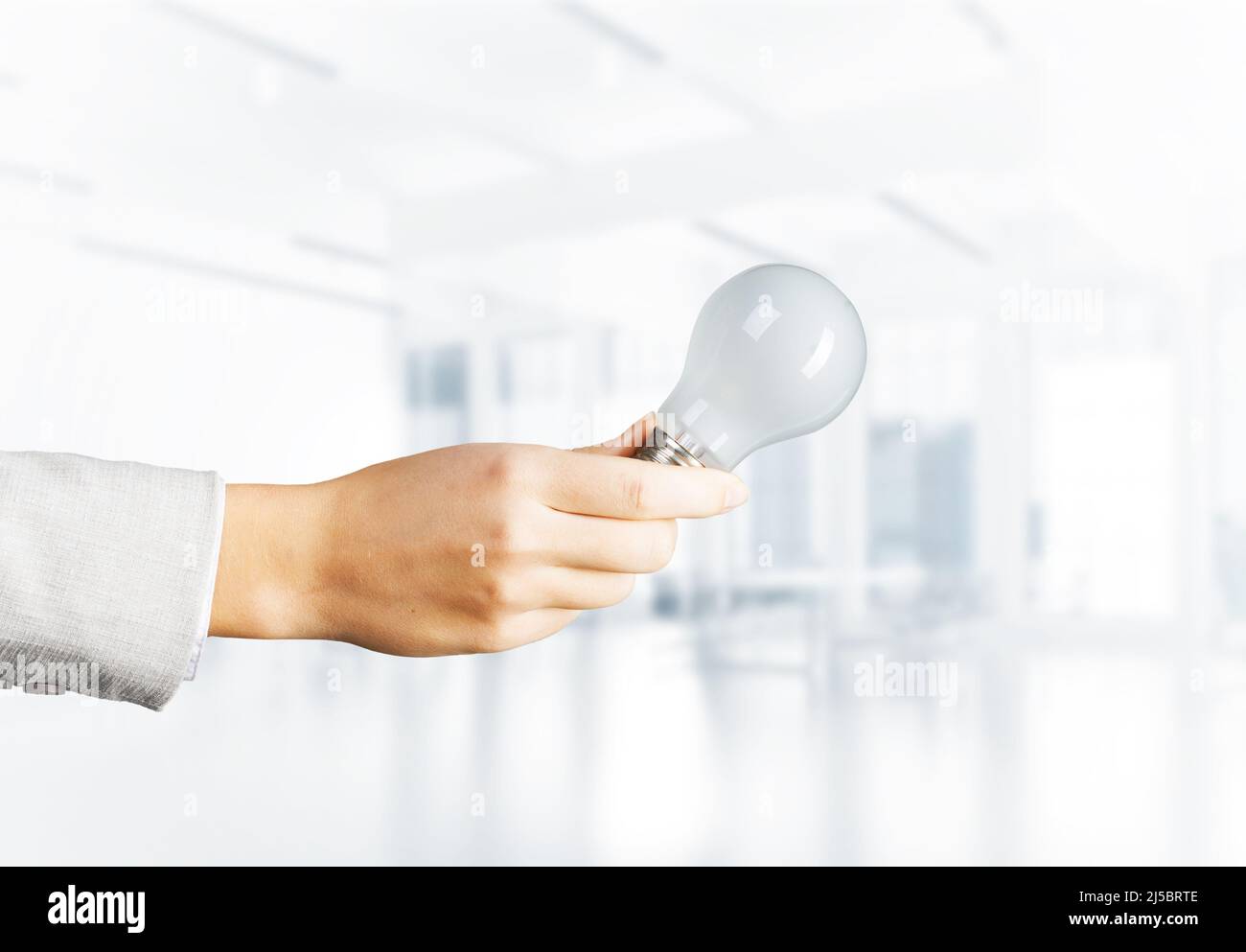 Human hand with glowing incandescent lamp Stock Photo - Alamy