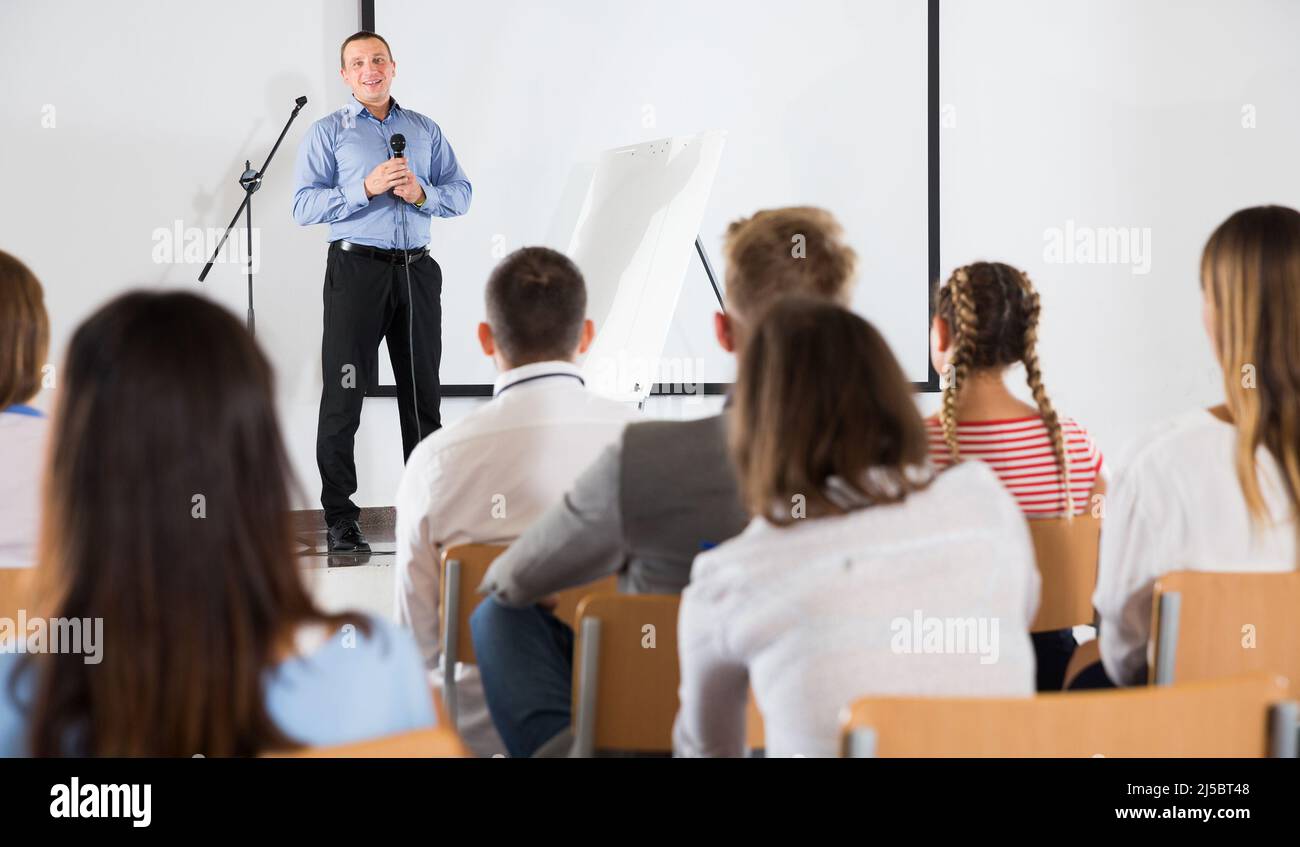 Male coach giving presentation Stock Photo - Alamy