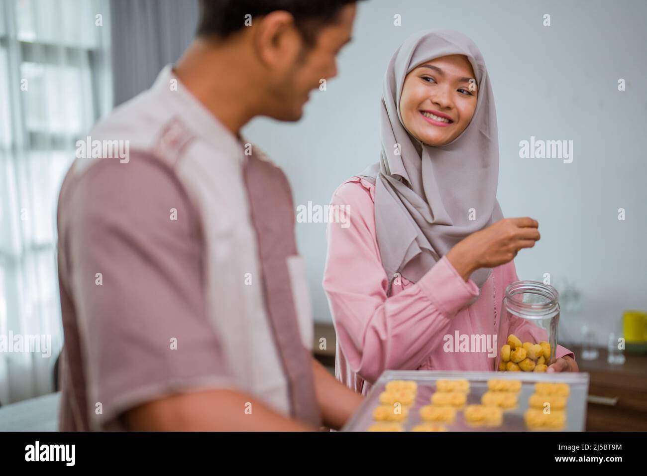 muslim man and woman bake nastar snack for idul fitri Stock Photo - Alamy
