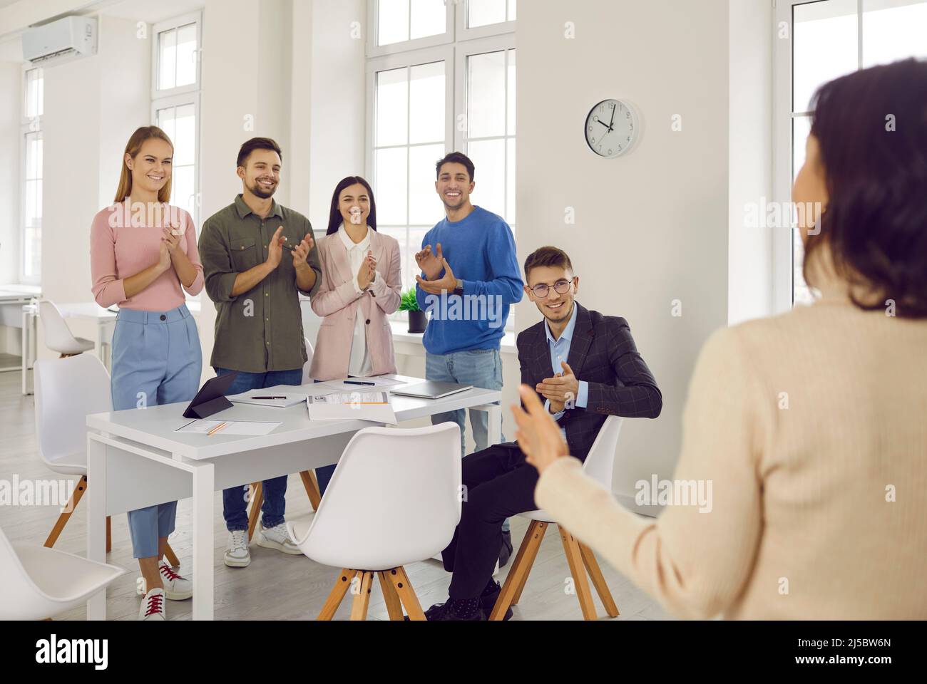 Businesspeople clapping congratulating team leader hi-res stock ...