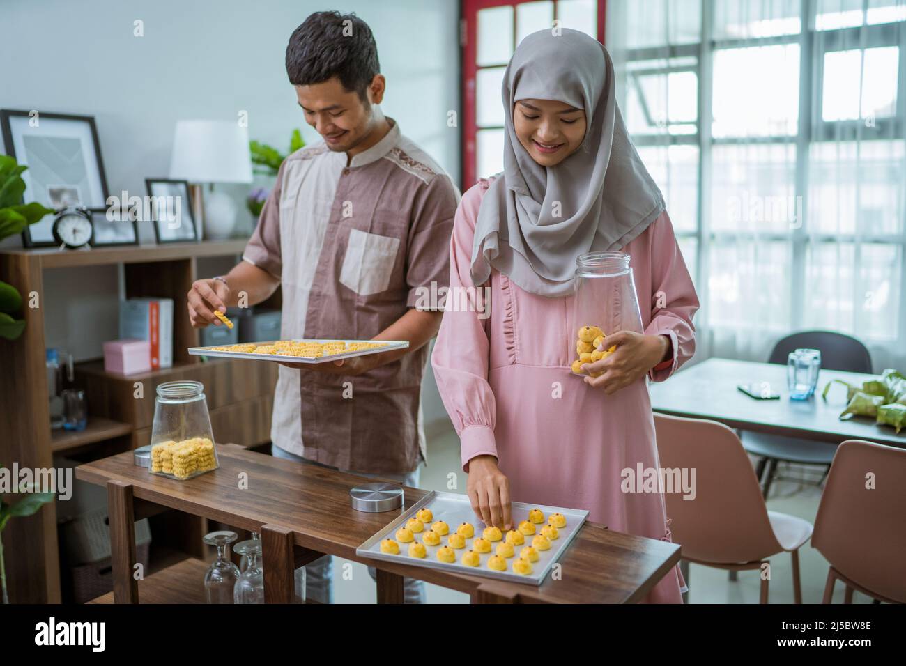 muslim man and woman bake nastar snack for idul fitri Stock Photo - Alamy