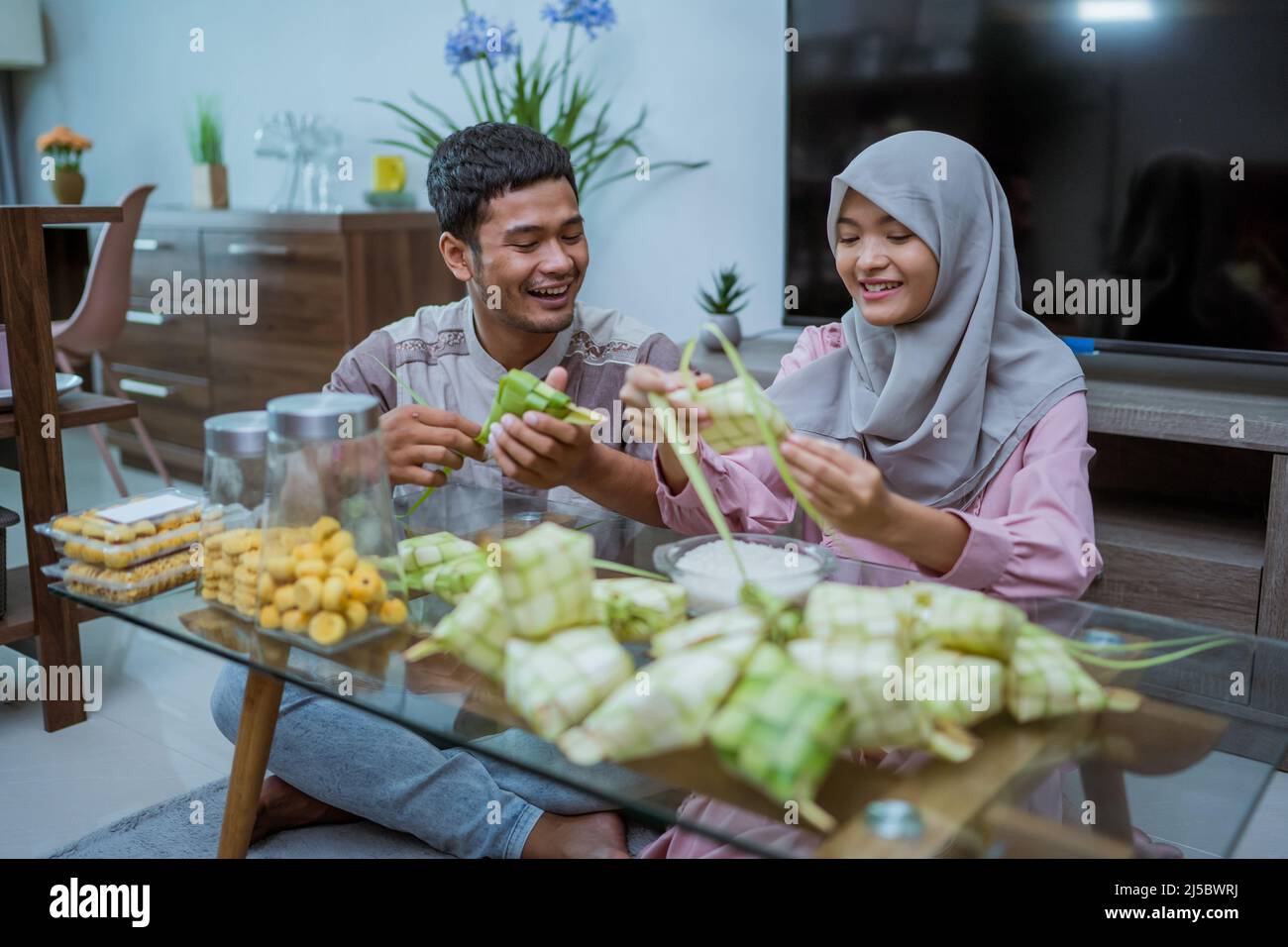 muslim couple making ketupat for idul fitri traditional delicacy Stock ...