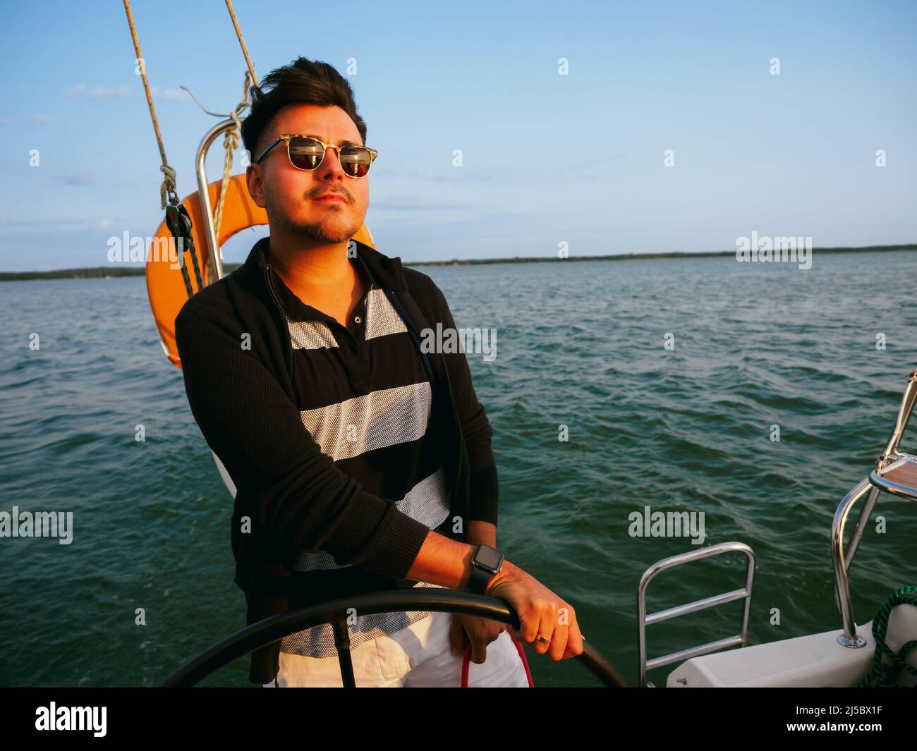 Sailor at the steering wheel of a sailing ship hi-res stock photography ...