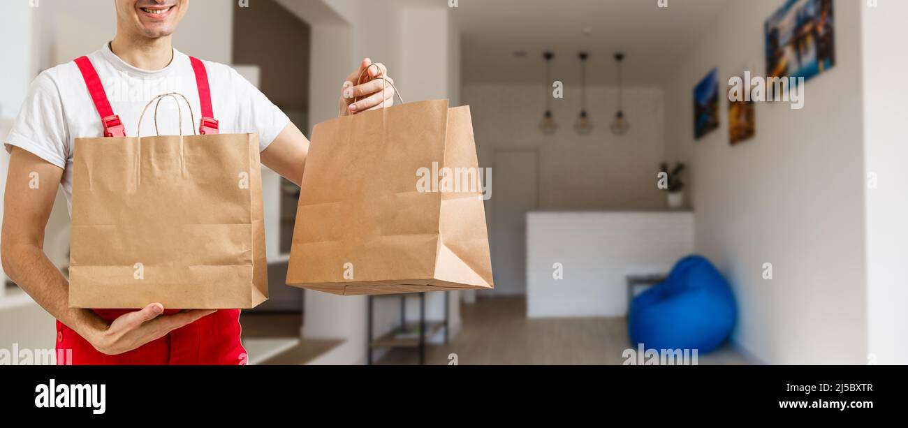 Close up of delivery man carrying boxes in commercial kitchen Stock ...
