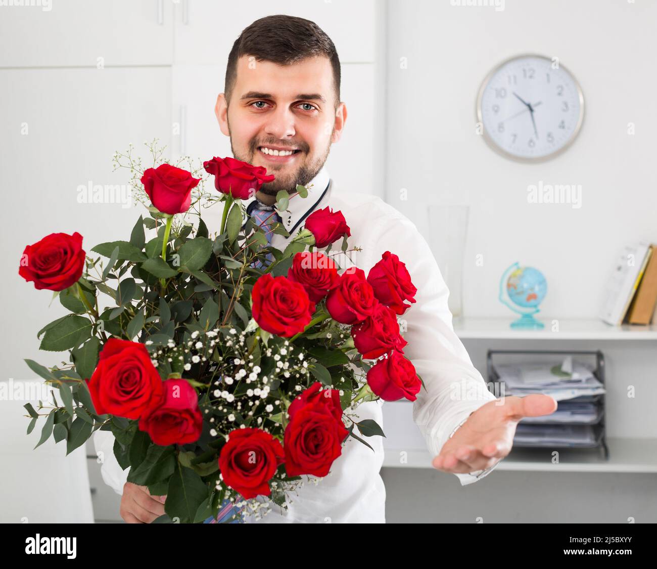 Present presenting gift of flowers hi-res stock photography and images ...