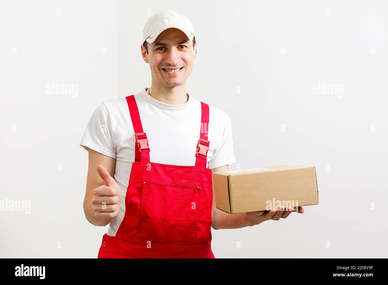 Portrait of happy worker unloading boxes from a delivery van and ...