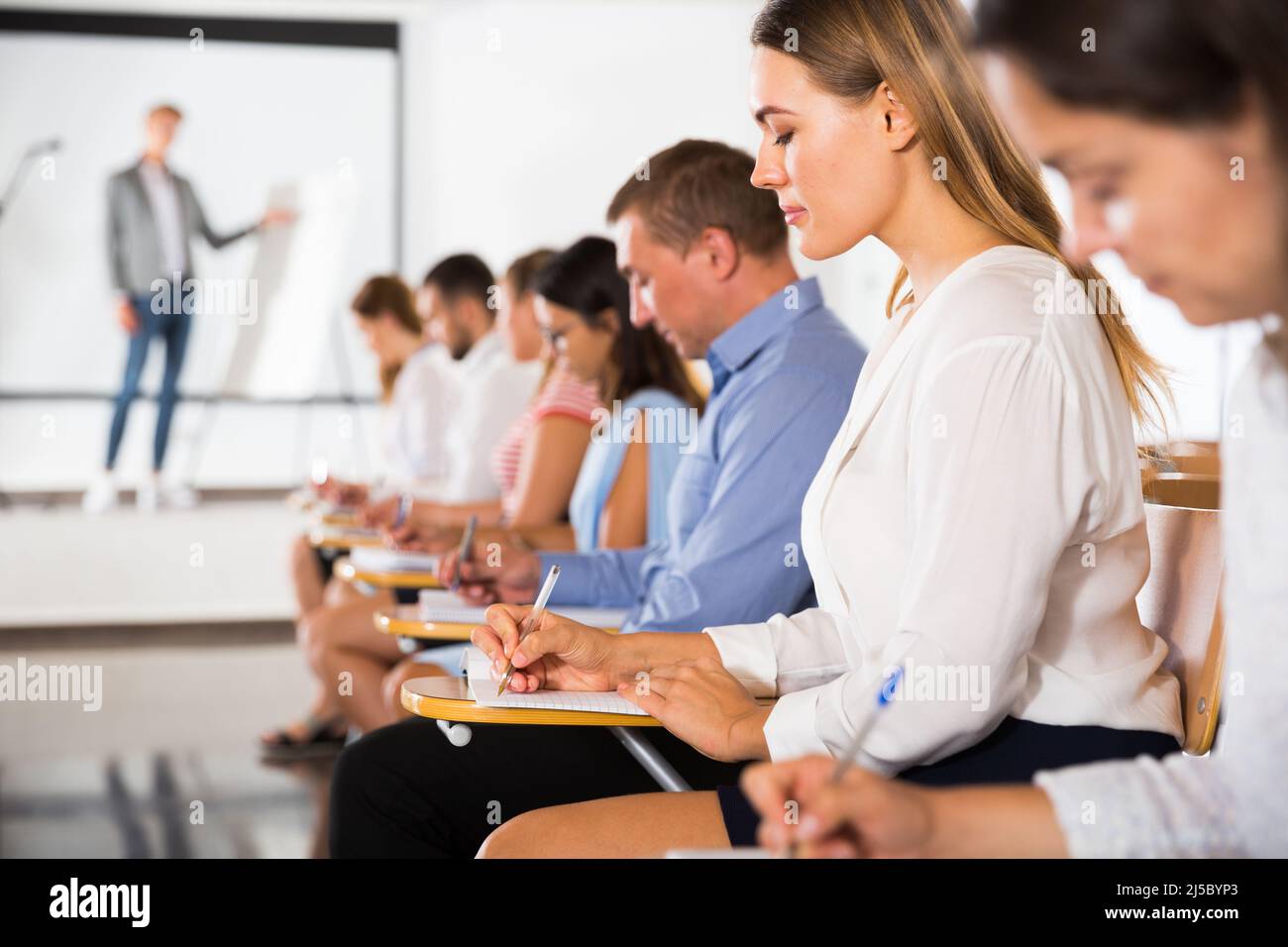 Side view of student group on lecture Stock Photo - Alamy