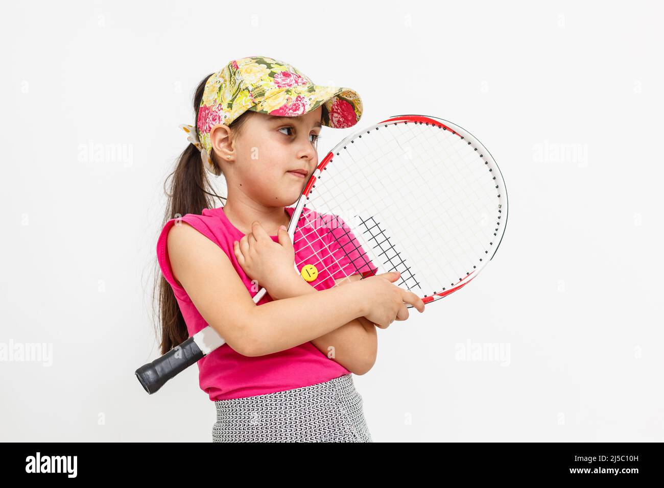 Cute little girl with tennis racket on white background Stock Photo - Alamy