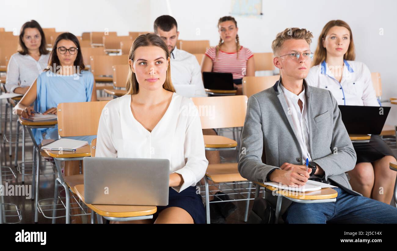 Group of people with laptops in lecture hall Stock Photo - Alamy