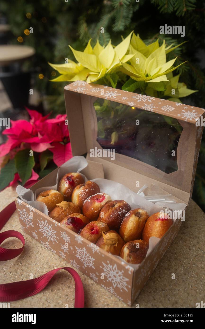 German donuts - berliner with filling and icing sugar in a box on a ...
