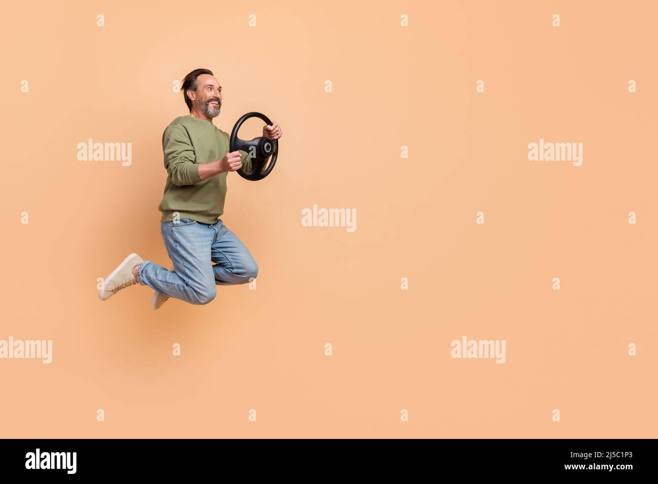 Full body profile portrait of crazy active person hold wheel look empty ...