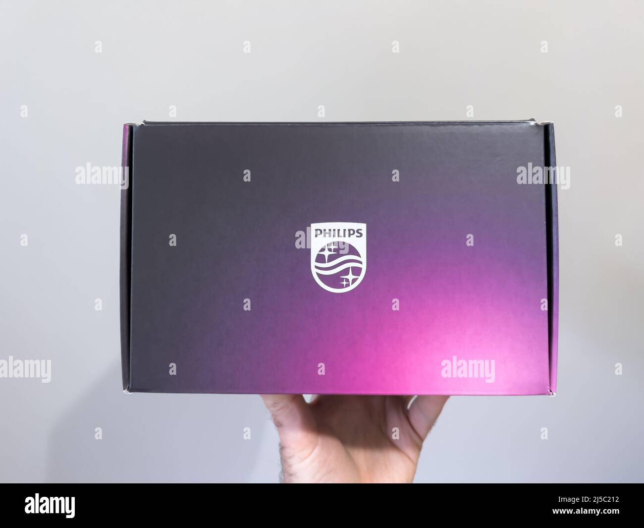 Paris, France - April 8, 2022: POV male hand holding new Philips Hue ...