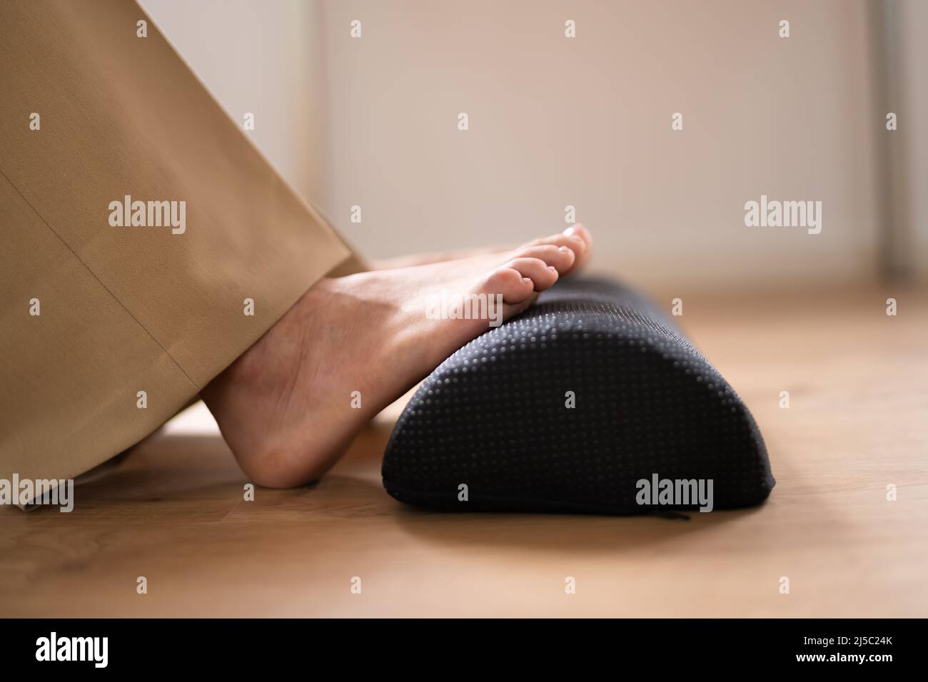 Worker Using Footrest To Reduce Back Strain And Feet Fatigue Stock ...