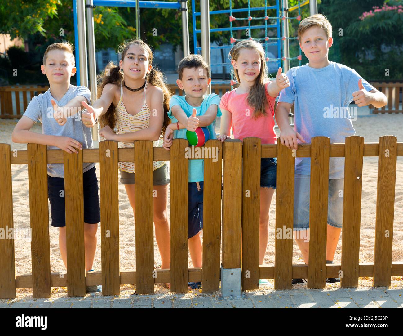 Kids posing at the playground and thumbs up Stock Photo - Alamy