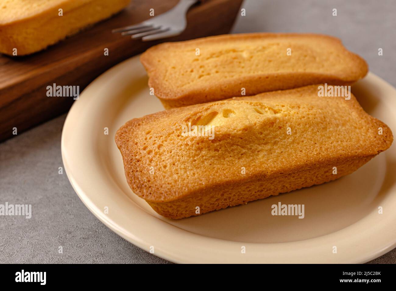 Sweet and savory gold ingot-shaped bread financier Stock Photo - Alamy
