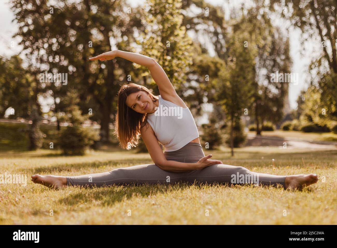 full length yoga concept. sporty slim woman with long dark hair sit in ...
