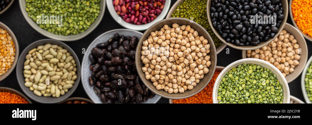 Banner of different types of legumes in bowls, green with yellow peas ...