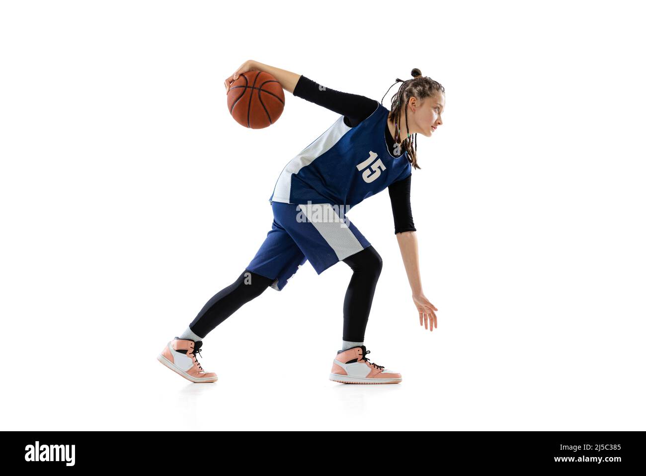 Portrait of teen girl, basketball player in motion, dribbling ball ...