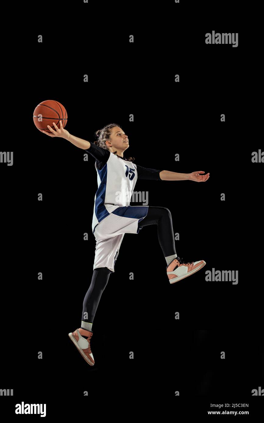 Jump shot. Scoring a goal. Portrait of teen girl, basketball player in ...