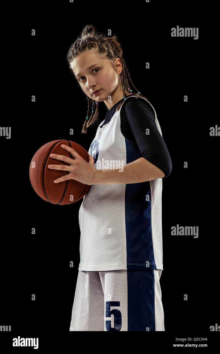 Portrait of teen girl, basketball player in uniform posing isolated ...