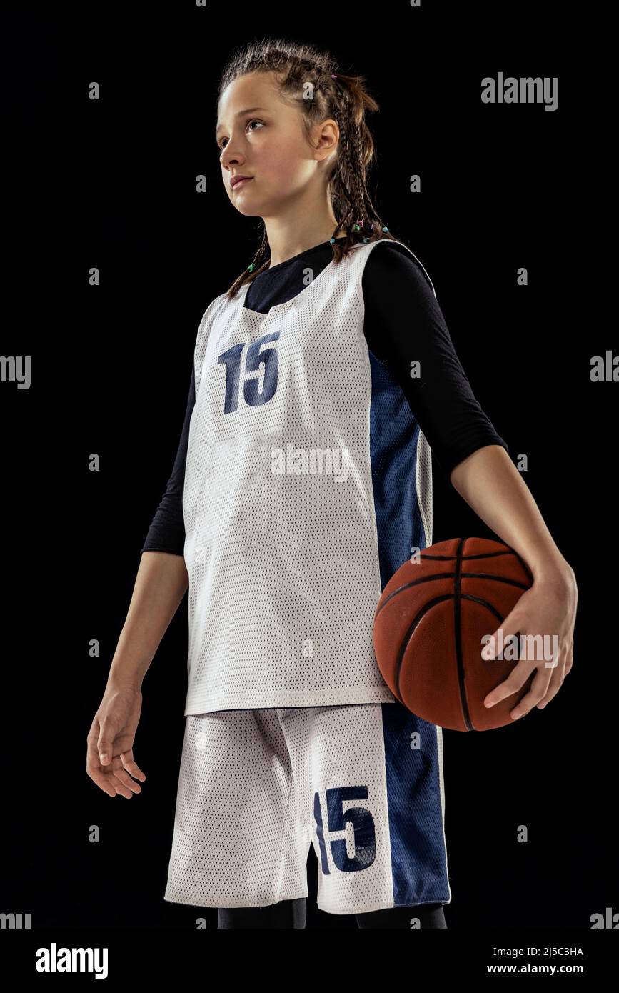 Portrait of teen girl, basketball player in uniform posing isolated ...