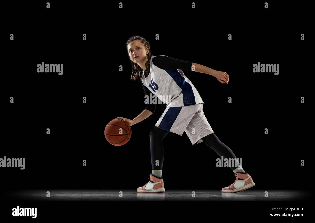 Portrait of young girl, basketball player in motion, training isolated ...