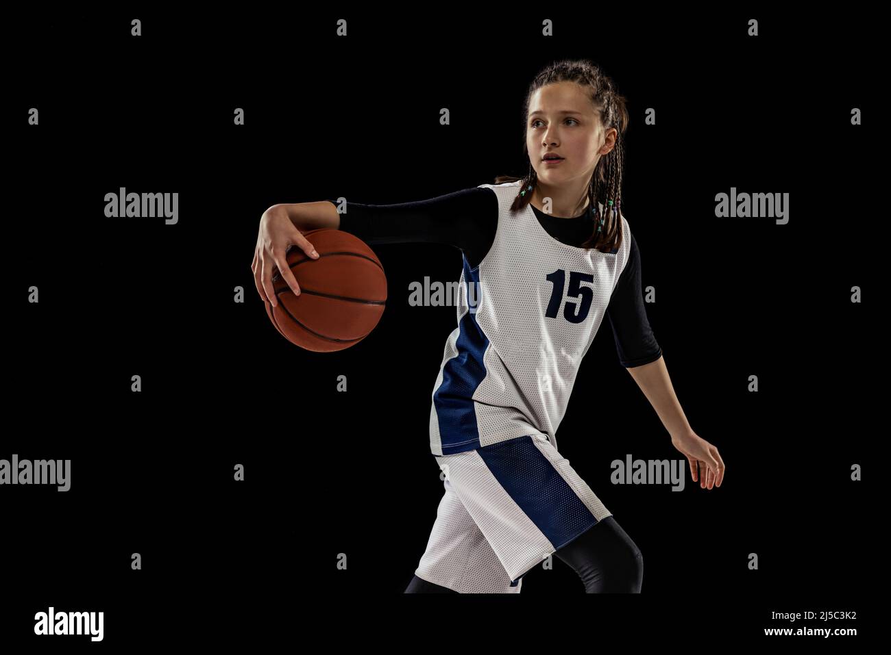 Teen girl playing basketball in gym hi-res stock photography and images ...
