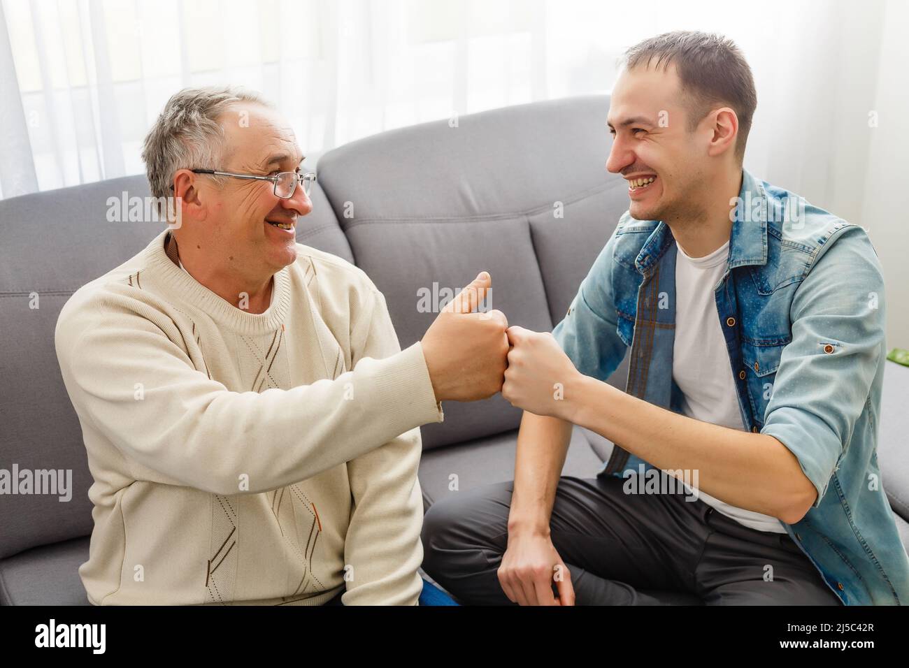 Two men in living room talking Stock Photo - Alamy