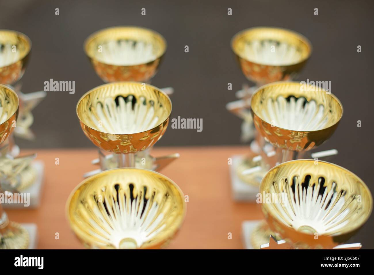 Winner's Cup. Gold Cups stand in row. Award to champions Stock Photo ...