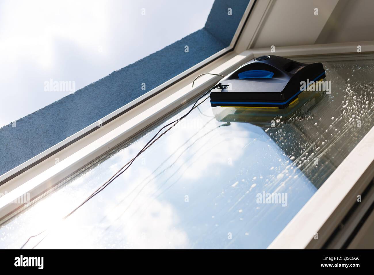 window cleaning robot at work background image with space for text ...