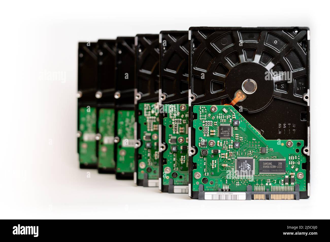 A row of 6 hard disk drives with front facing circuit boards Stock ...
