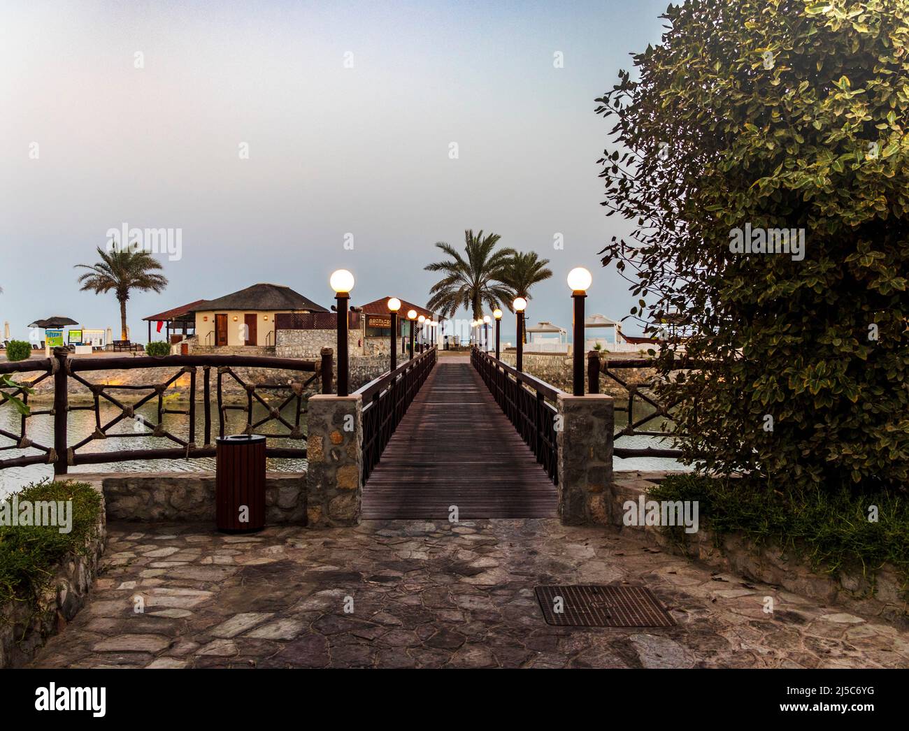 Ras Al Khaimah, UAE - 04.04.2022 - Wooden bridge leading to the beach ...