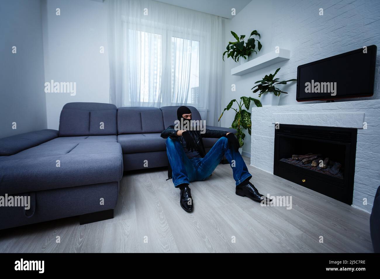 Robbery. The guy robs the house and runs away with the loot Stock Photo ...