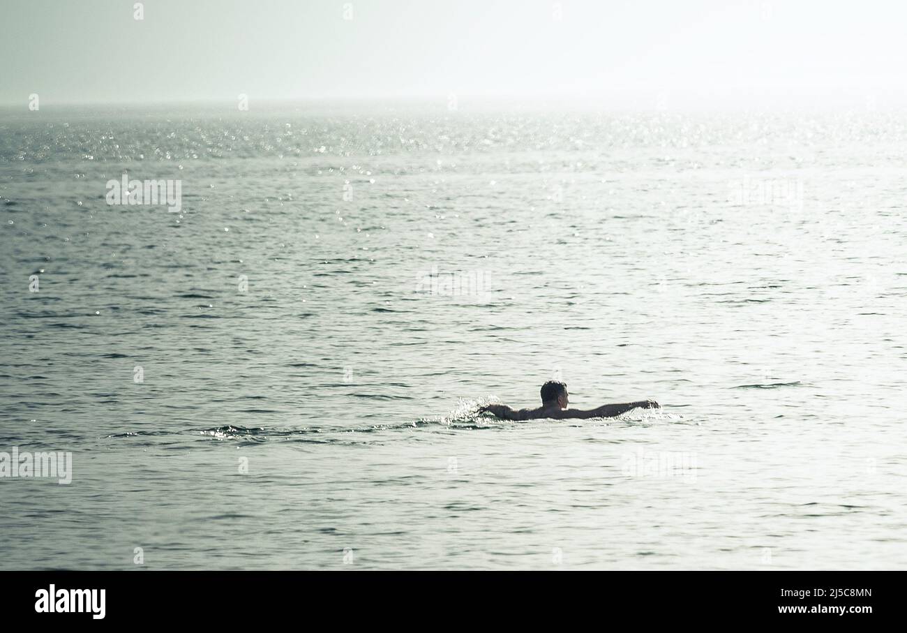 lone swimmer at open sea Stock Photo - Alamy