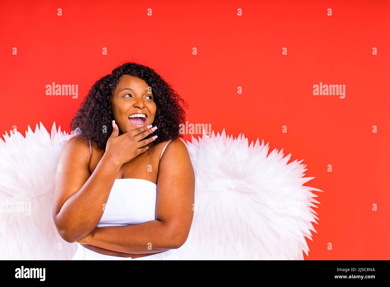 spain cheerful angel with wings on red background studio Stock Photo ...