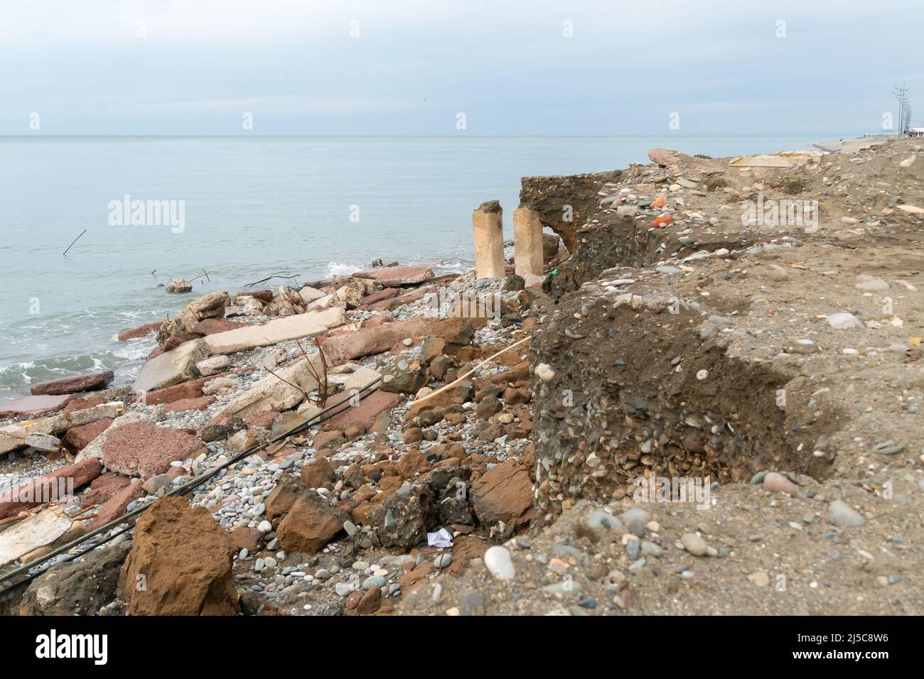 Destroyed embankment after the storm. the collapse of the ground ...