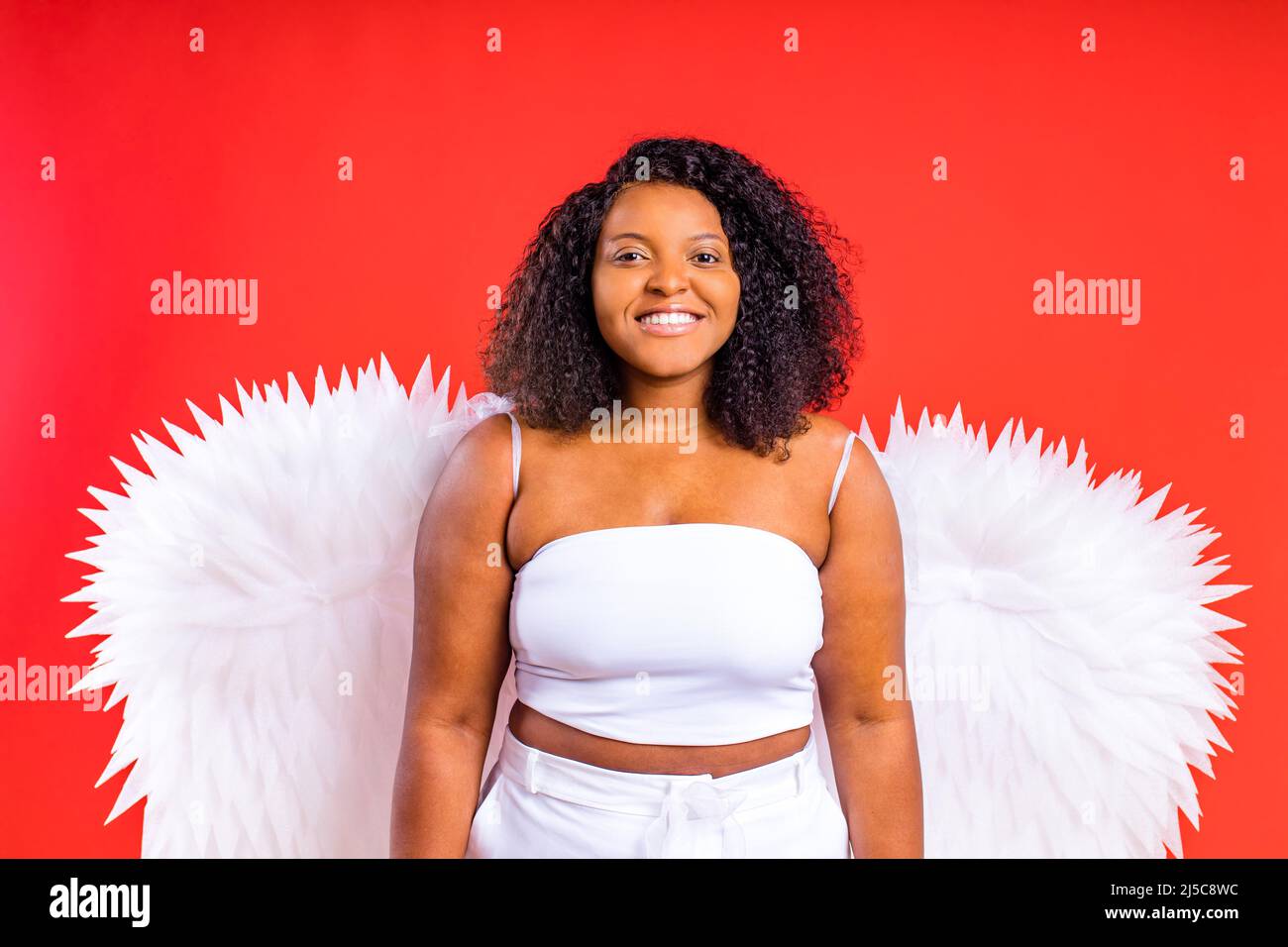 spain cheerful angel with wings on red background studio Stock Photo ...