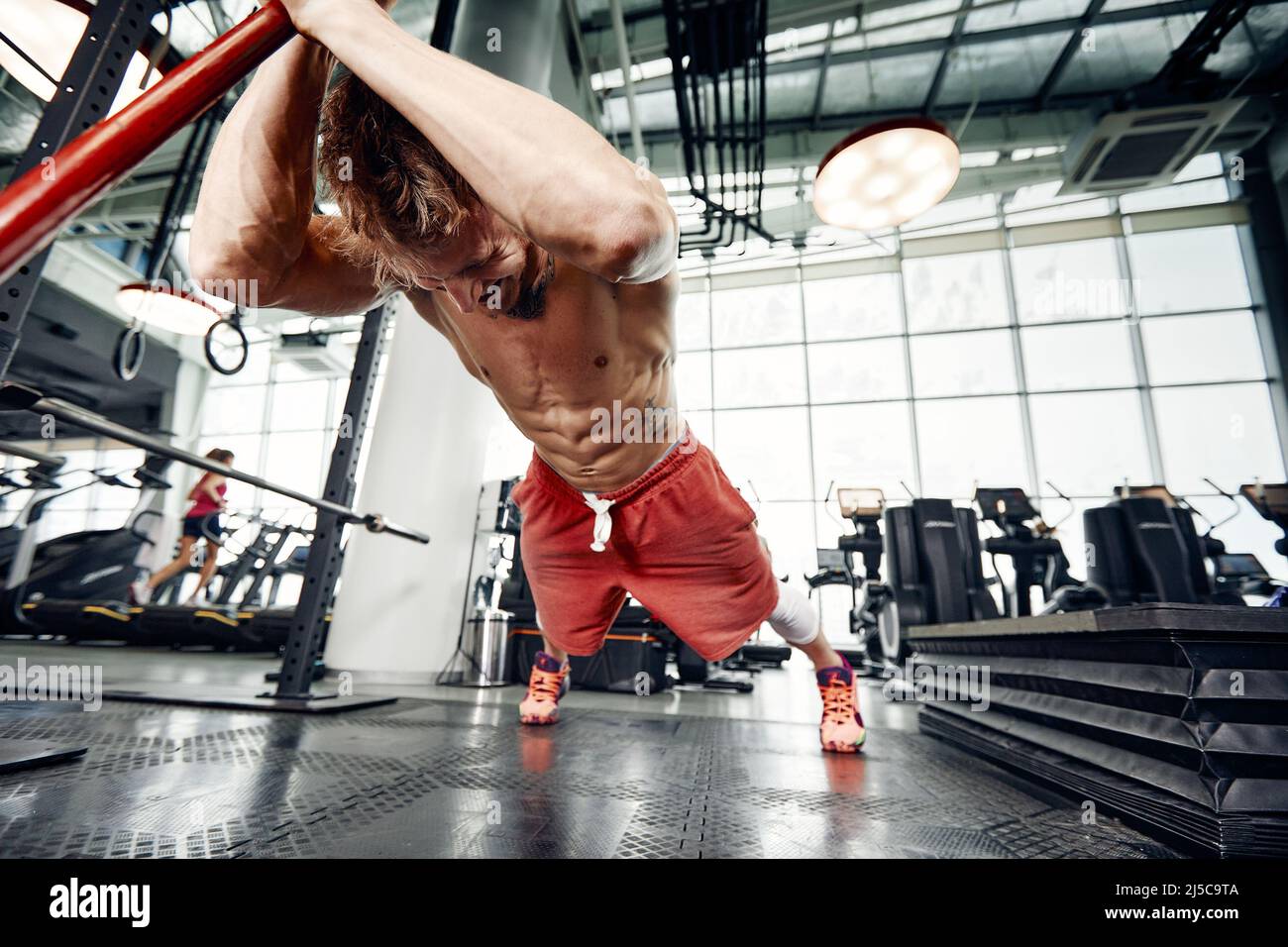 Man fitness training with large and heavy tire hits hammer. Concept ...