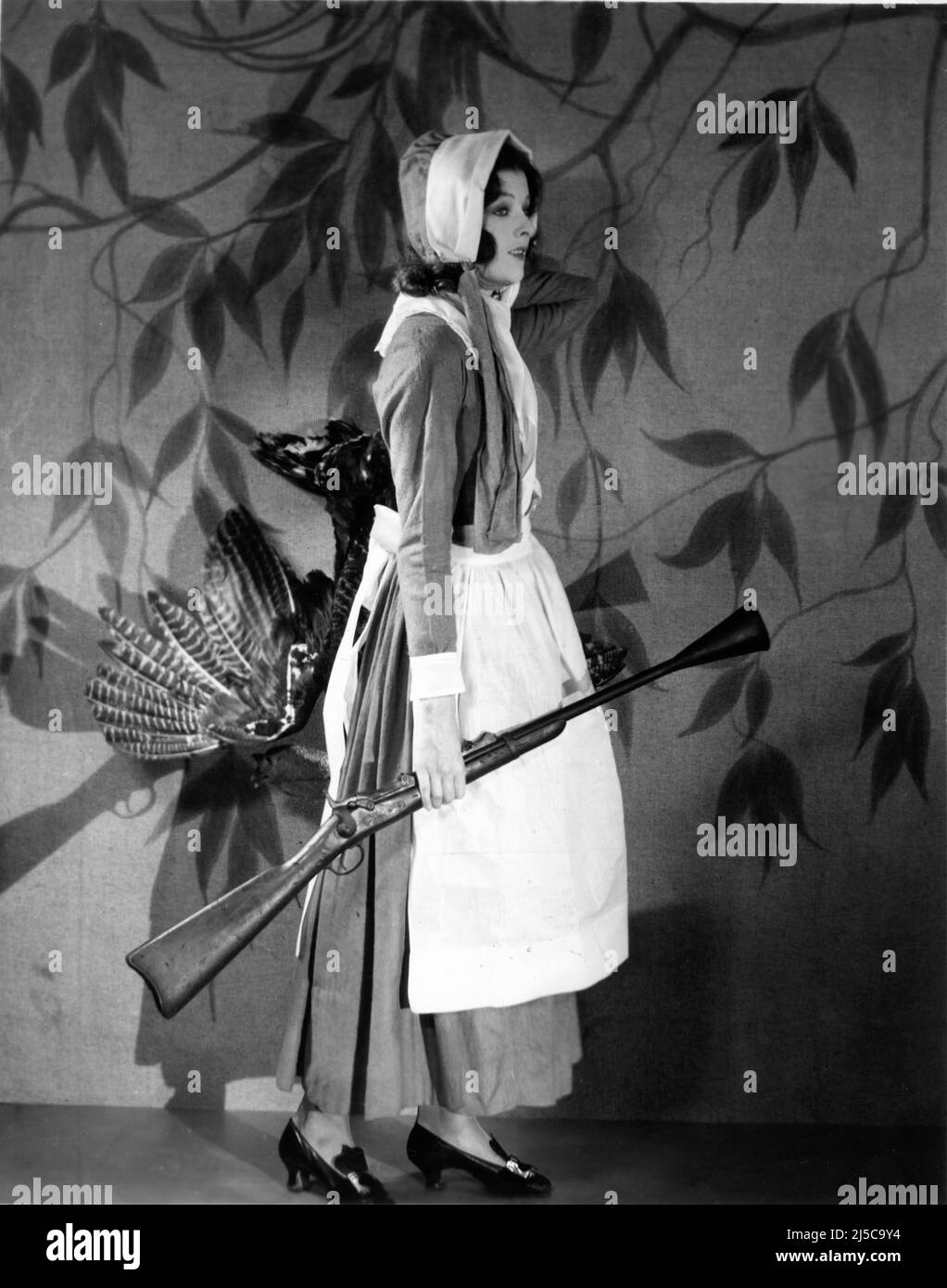 MYRNA LOY 1928 Thanksgiving portrait as female Pilgrim with gun and ...